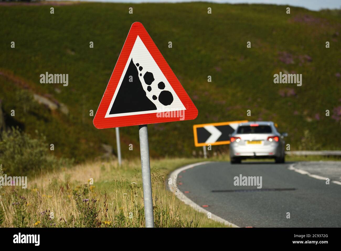 Falling rocks and tight bends chevrons on a rural A-road in North ...