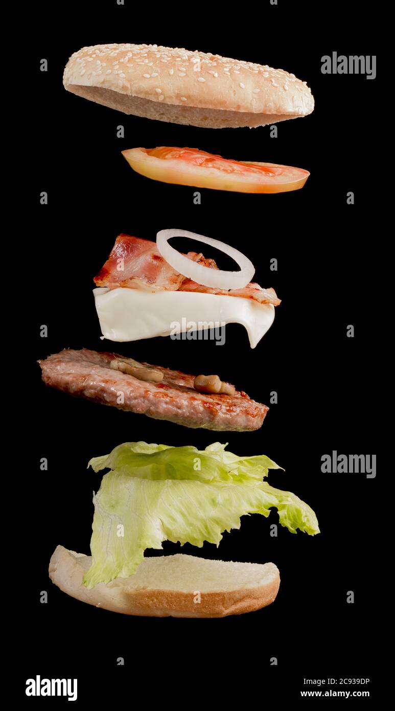 Vertical shot of the parts of a sandwich floating in the air with a ...