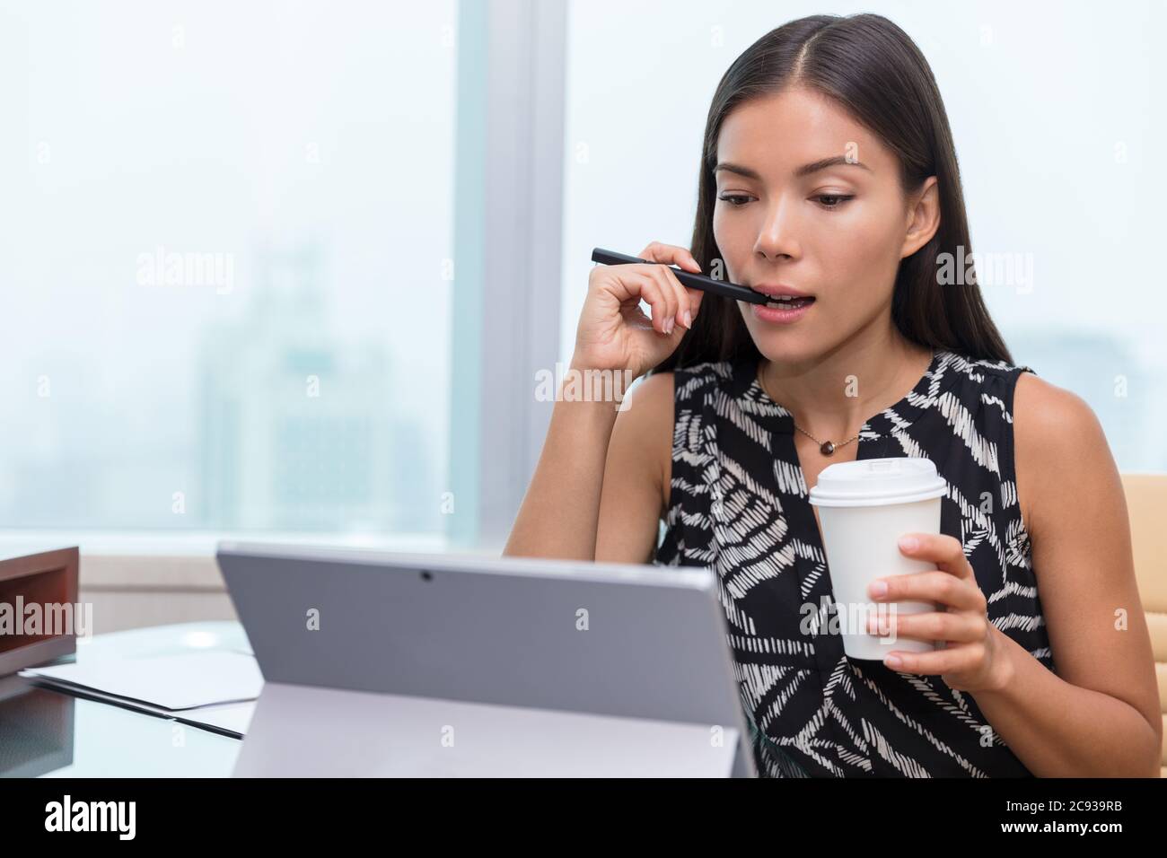 Asian business woman busy working on office laptop Stock Photo - Alamy