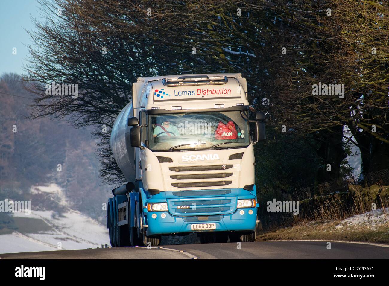 Lomas Group Scania tanker driving along a Derbyshire A Road in Winter ...