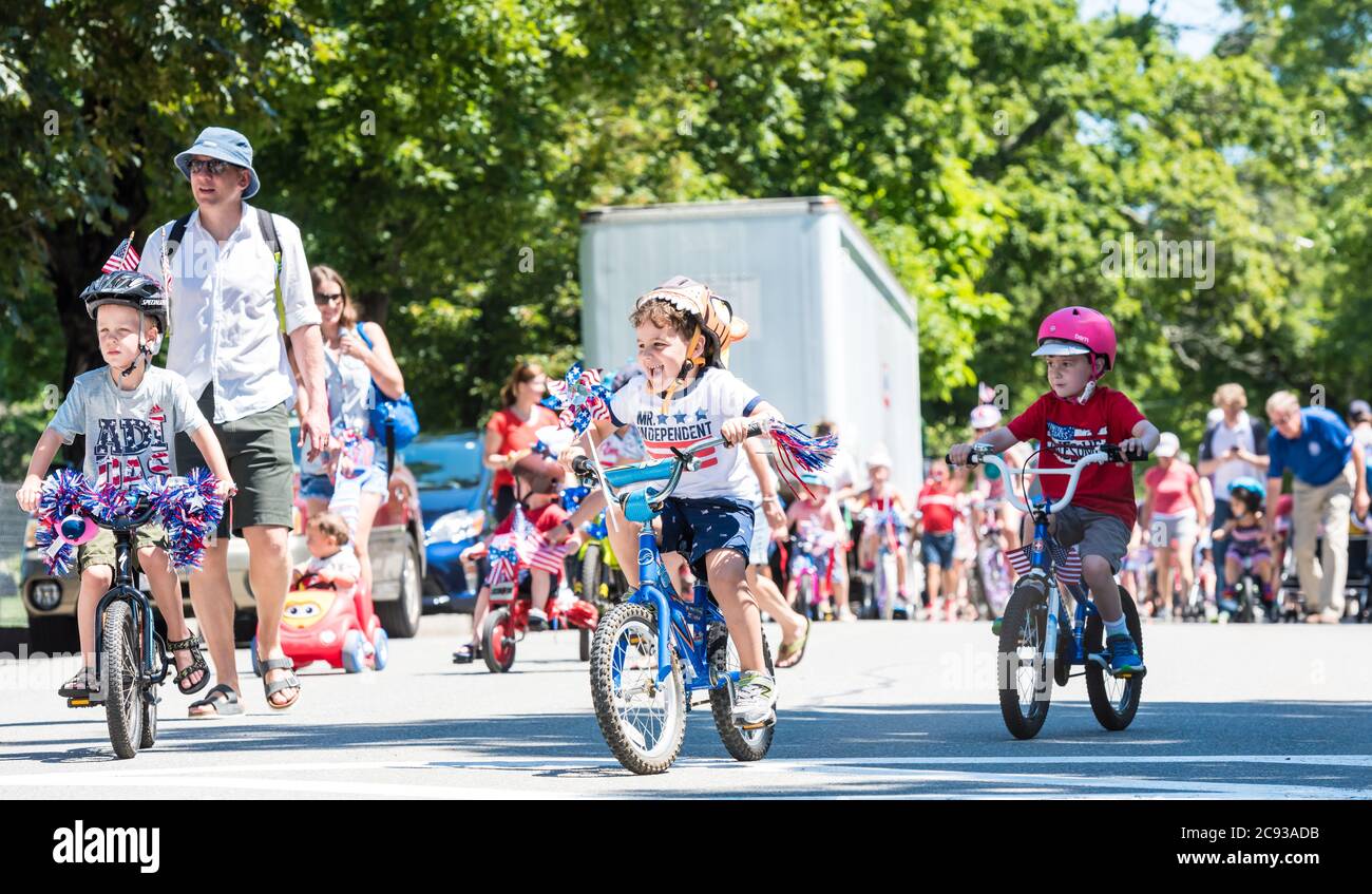 Kids on bikes in a parade at the beginning of Picnic in the Park ...