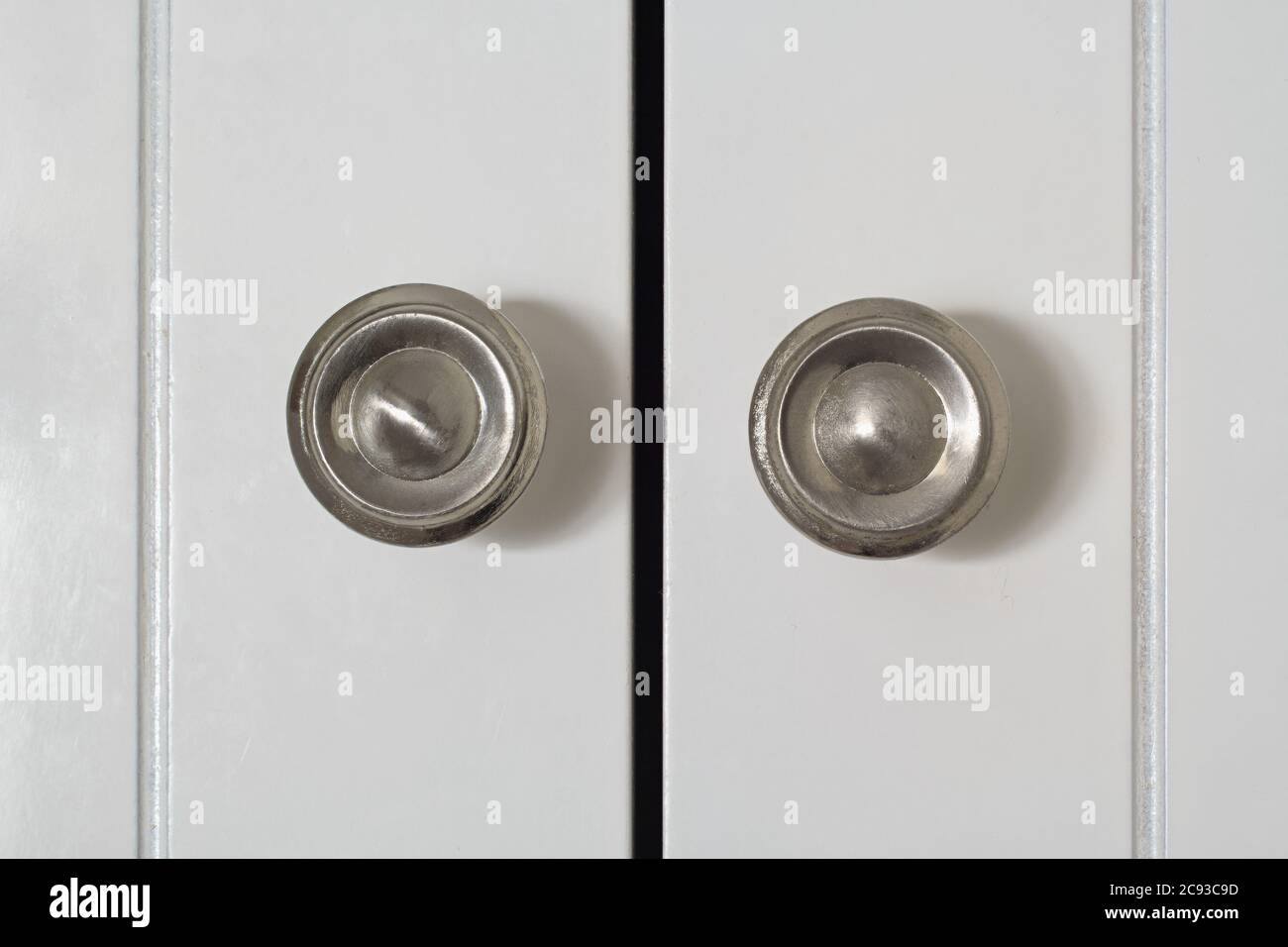 Round knobs on white cupboard door in natural window light Stock Photo ...