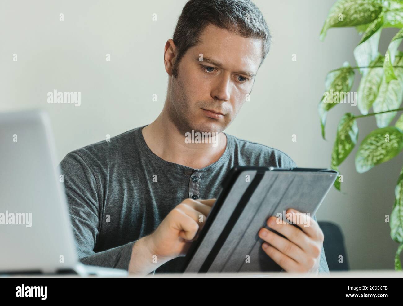 Man using tablet pc in the office Stock Photo - Alamy