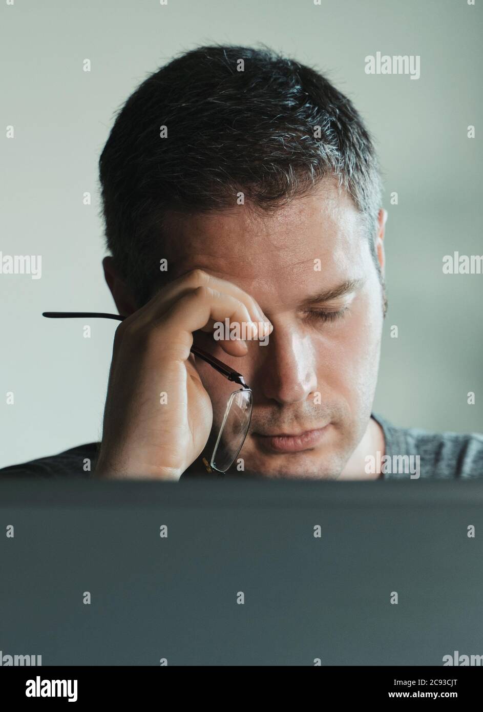 Tired man with eyes fatigue at work Stock Photo - Alamy