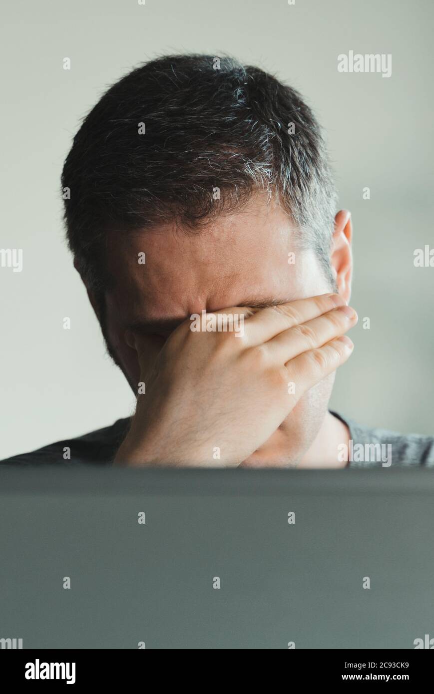 Tired man with eyes fatigue at work Stock Photo - Alamy