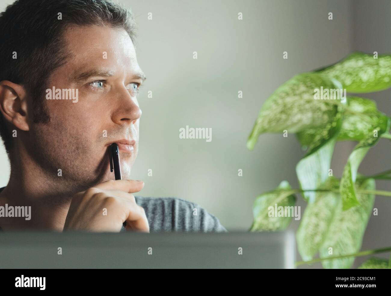 Thoughtful handsome man in front of his laptop in the office Stock ...