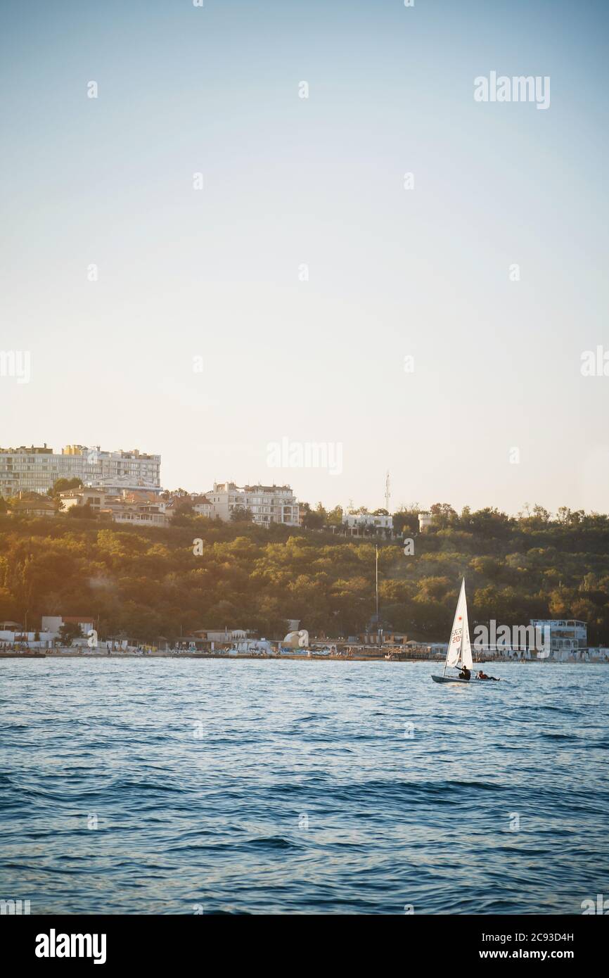 Nice view of small sailboat, yacht sailing in sunset at regatta Stock ...