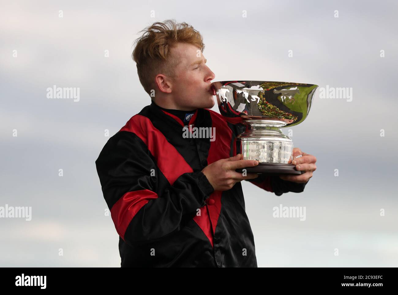 Jockey Gavin Ryan with the trophy after winning the COLM QUINN BMW Mile ...