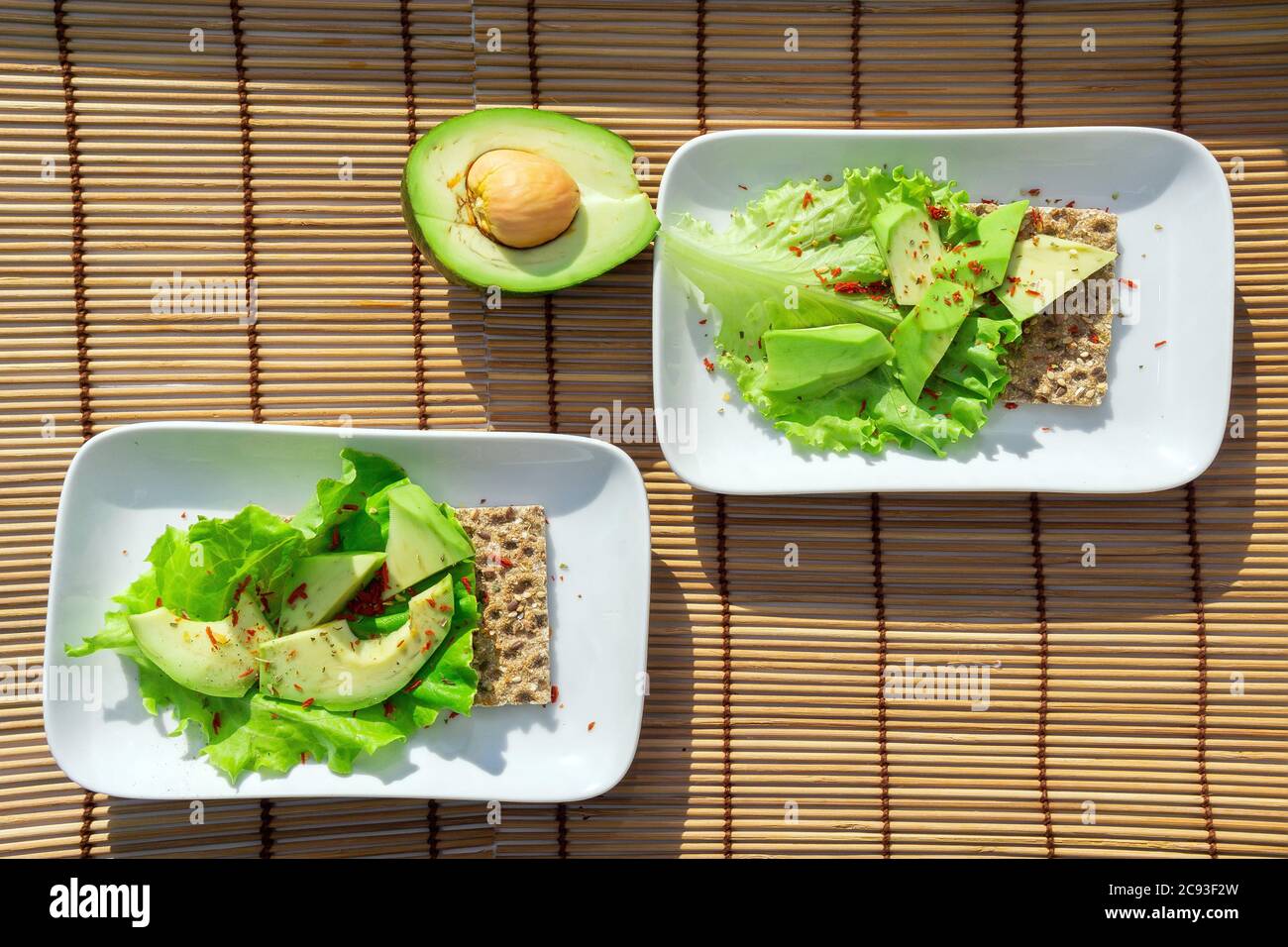 Snack from wholegrain rye crispbread cracker with avocado and salad ...