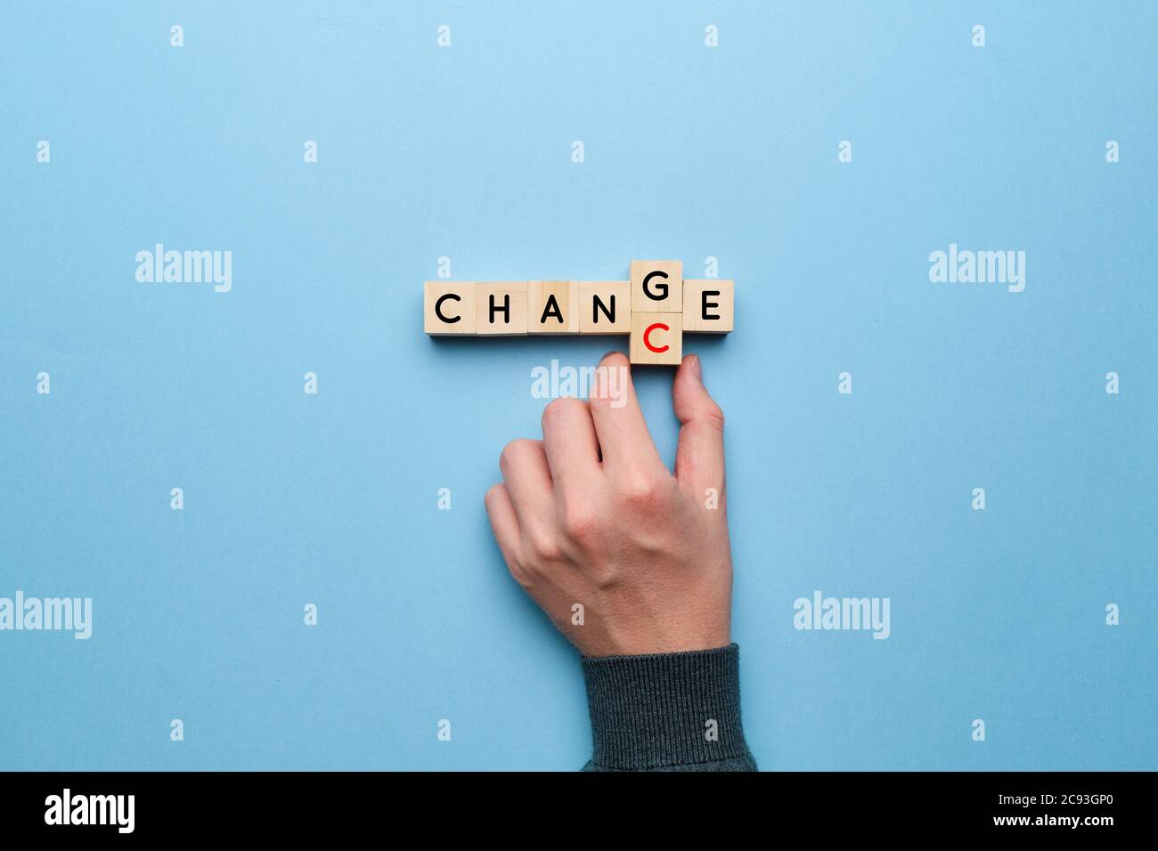 The concept of change and chance. Hand picks up letters on a yellow ...