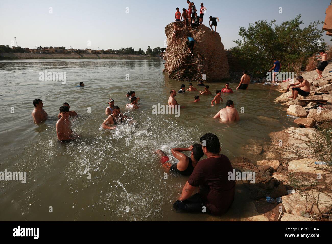 Baghdad, Iraq. 28th July, 2020. People take a swim in the Tigris River ...