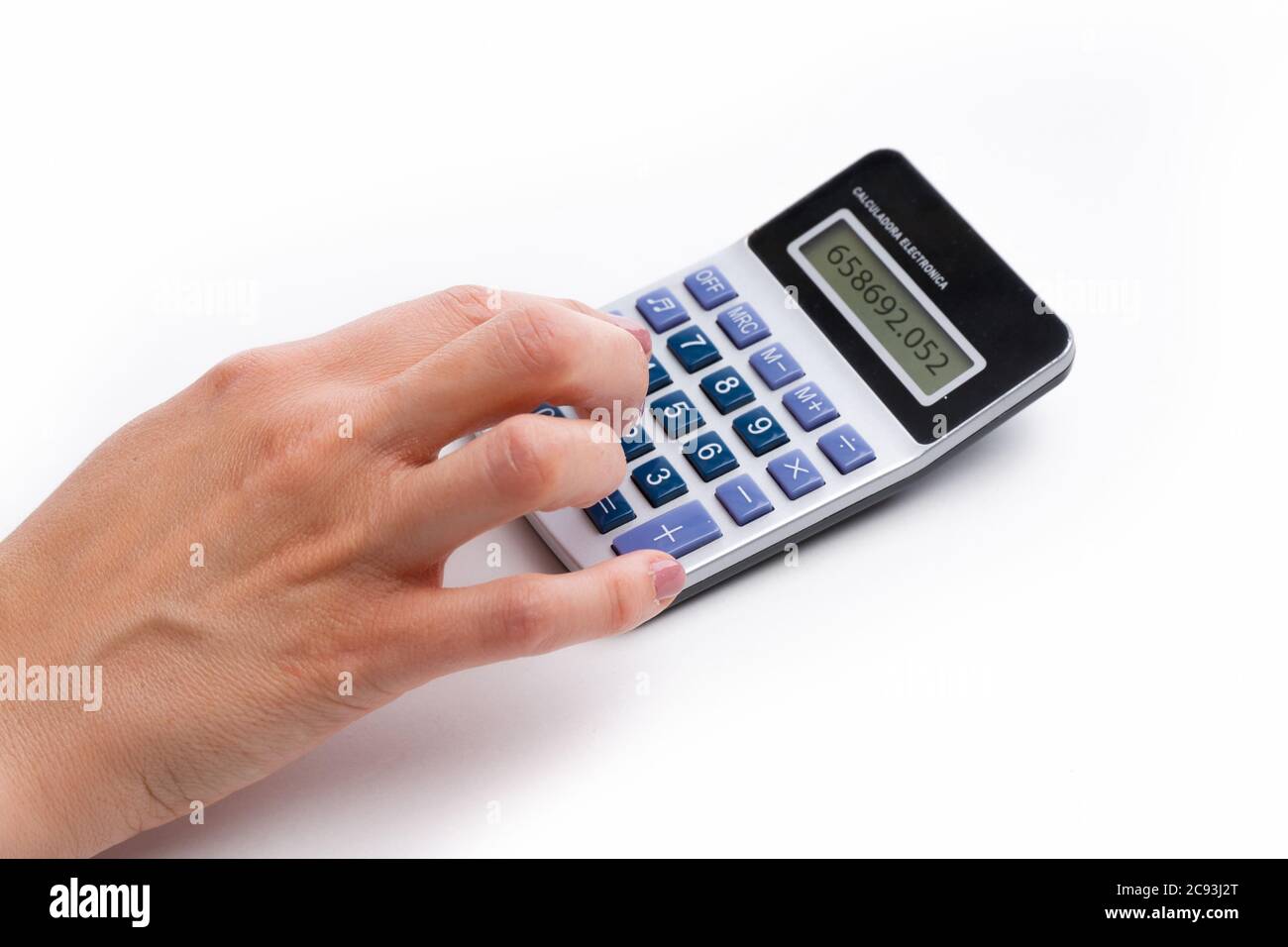 Person's hand doing some calculations on the calculator isolated on a ...