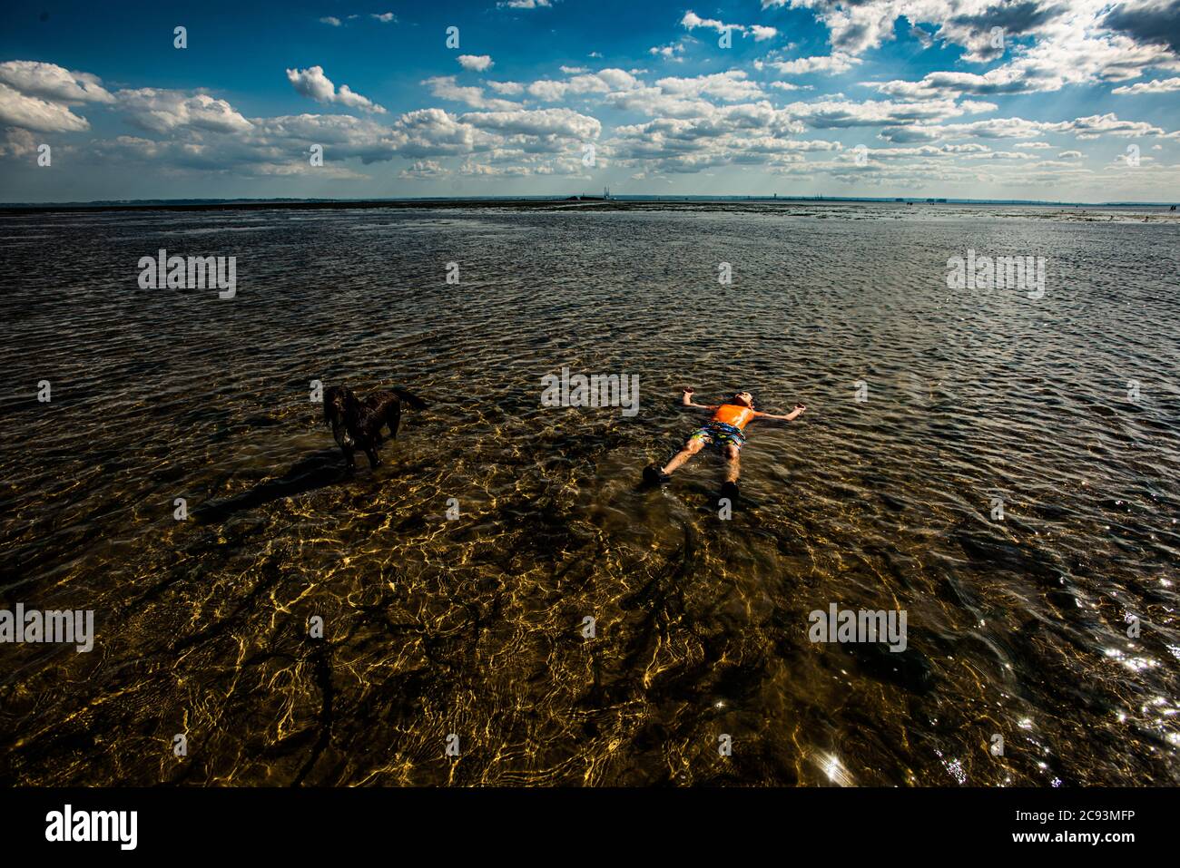 Boy floating in sea Stock Photo - Alamy