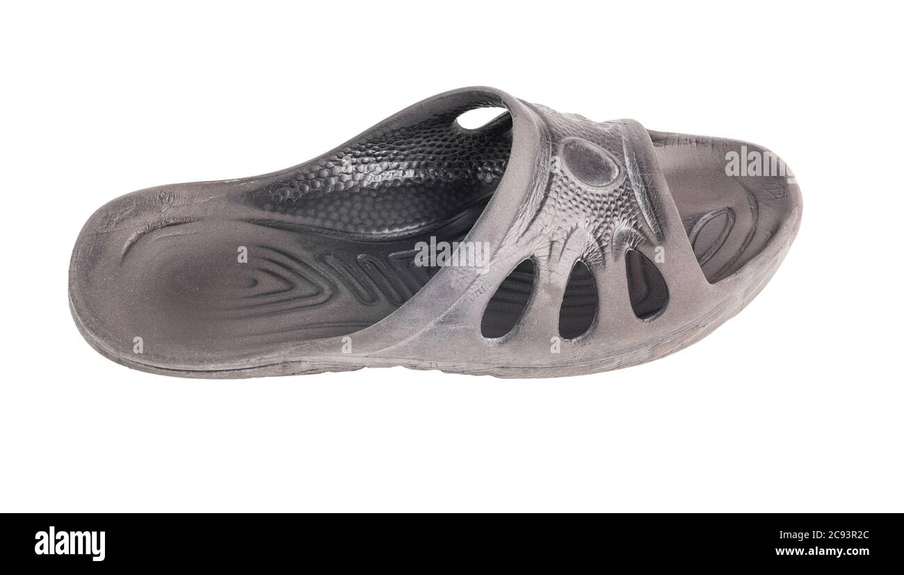 one used cheap black soft rubber slipper with signs of friction wear ...