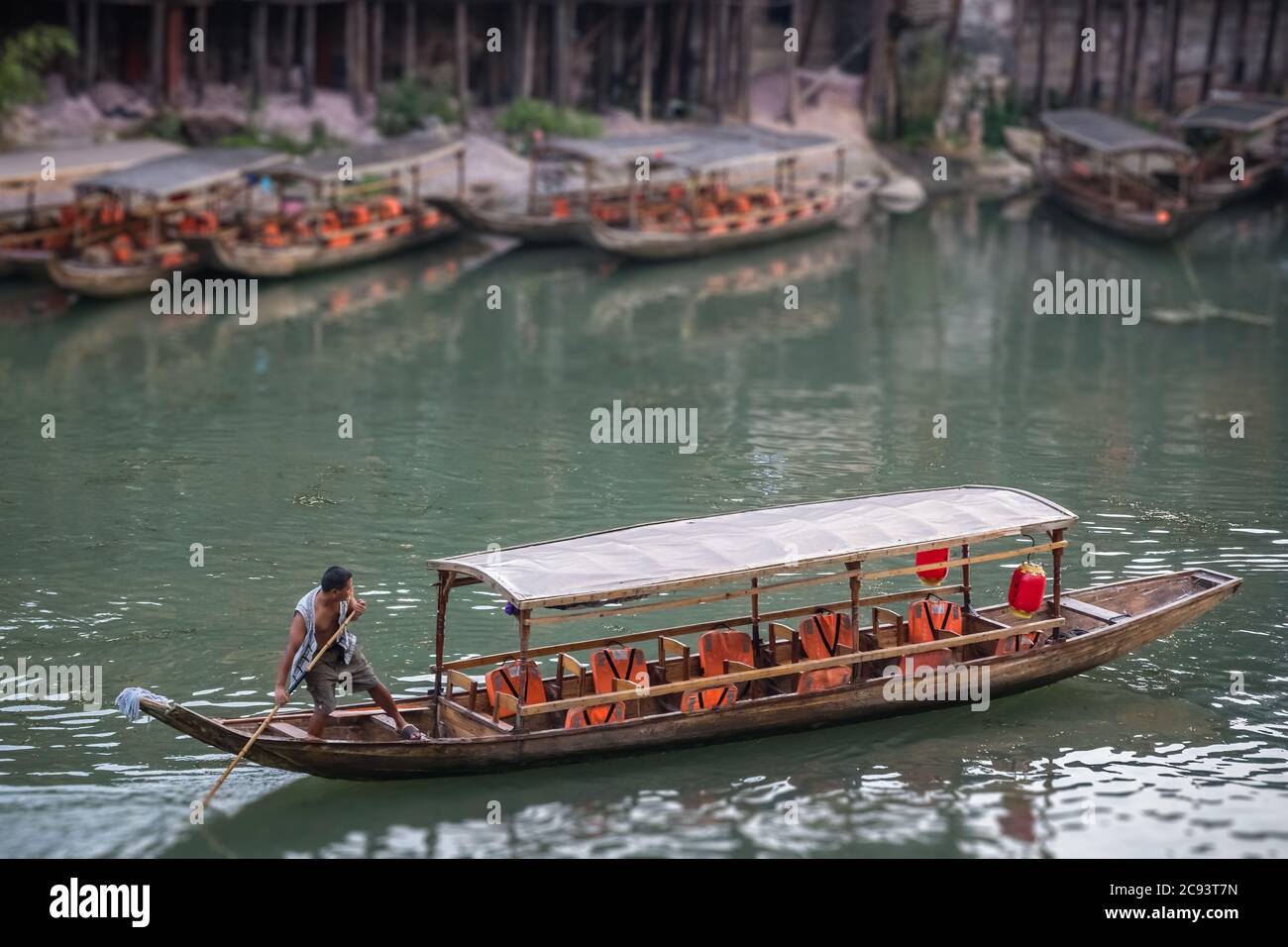 Feng Huang, China - August 2019 : Chinese boatman with a long pole used ...