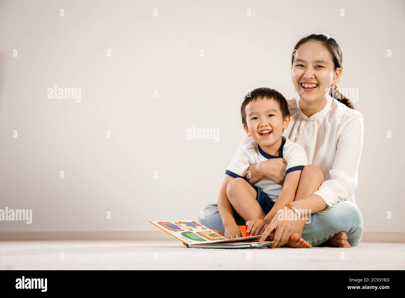 Asian mother and child reading book together concept. Vietnamese mum ...