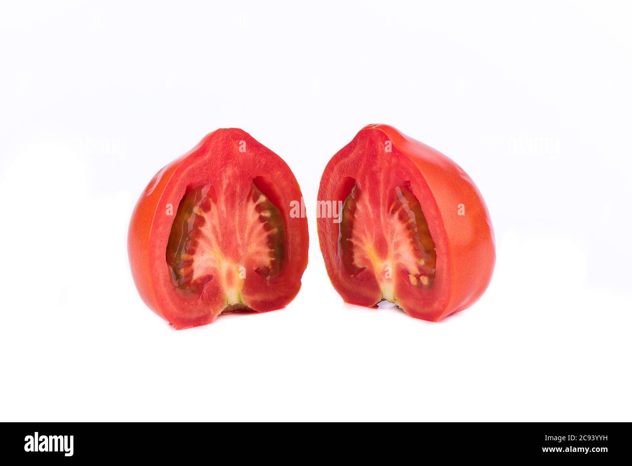 Ripe juicy tomato halves are isolated on a white background. Close up ...