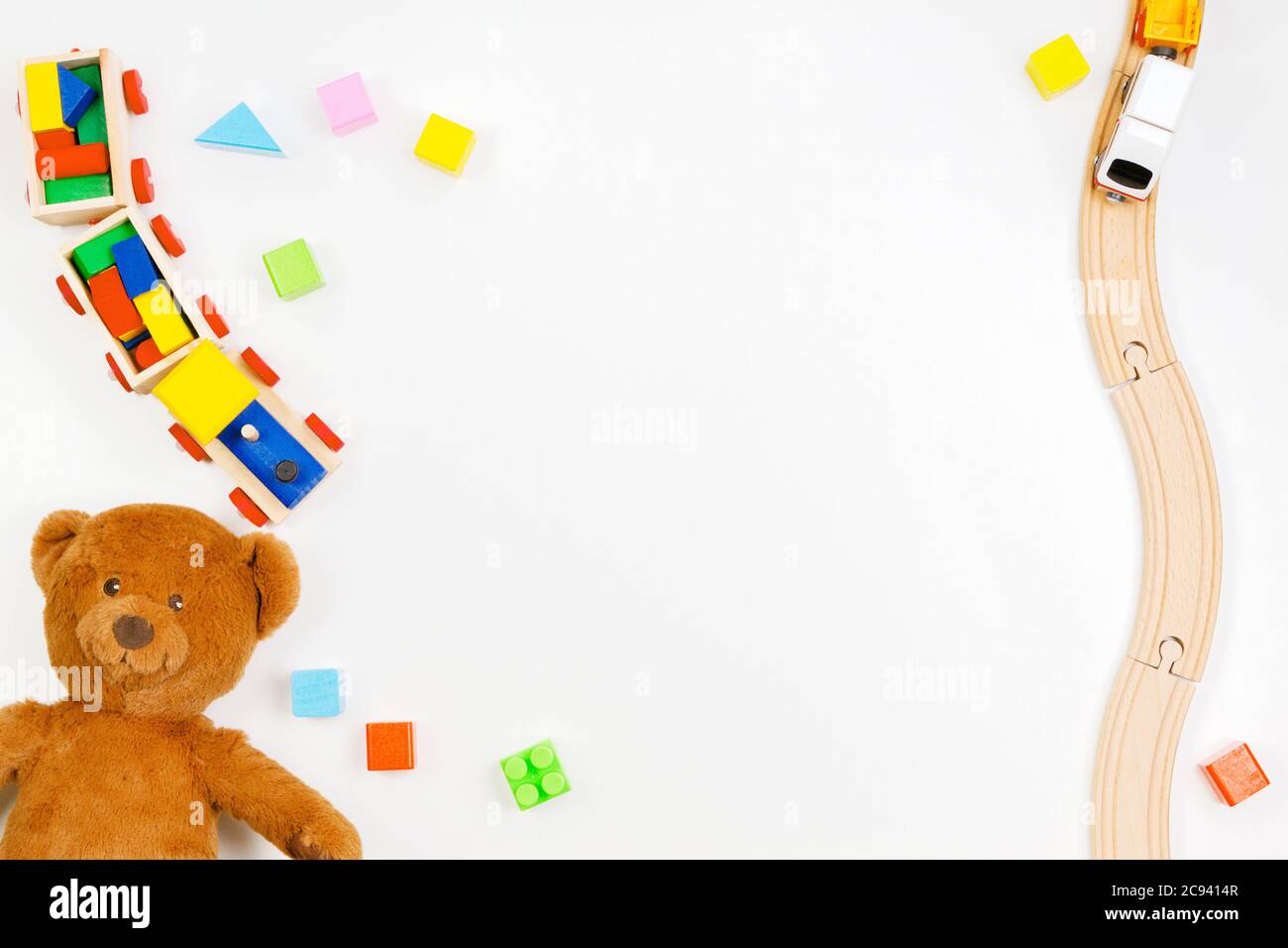Baby kids toys background. Teddy bear, wooden train, colorful bricks on ...
