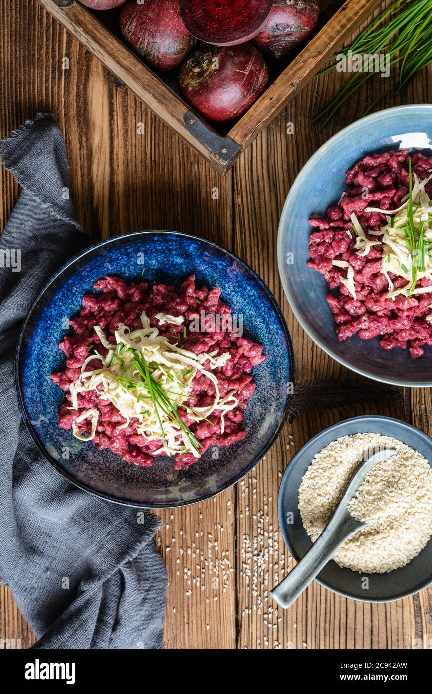 Flavorful boiled beetroot dumplings topped with hummus, smoked tofu and ...