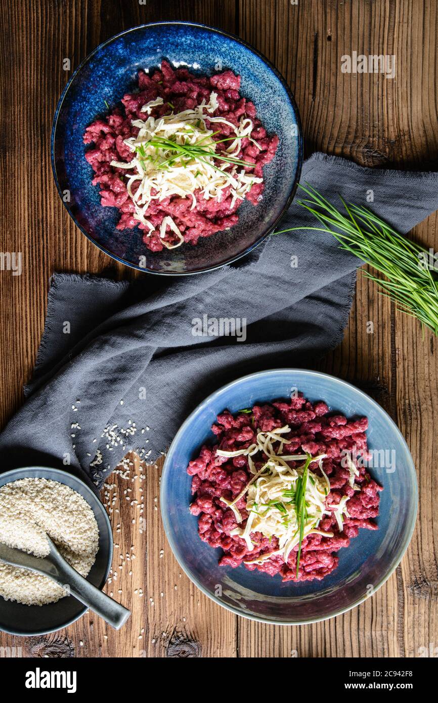 Flavorful boiled beetroot dumplings topped with hummus, smoked tofu and ...