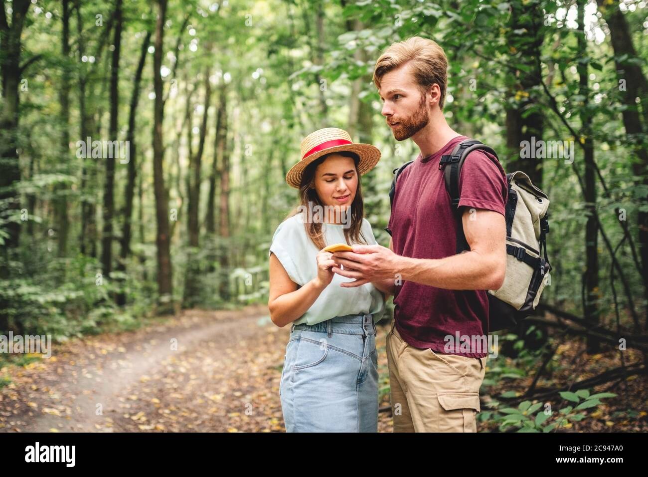 Hikers using mobile gps for directions. Happy couple checking ...