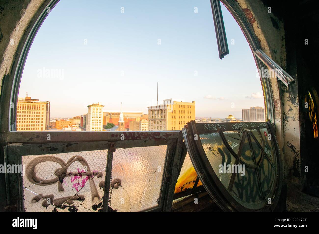 Looking Out a Large and Broken Arched Window at a City Skyline and ...