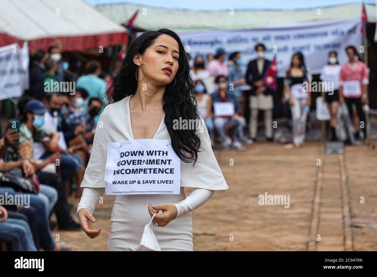 A model with a placard cat walking during the protest.Models catwalk in ...