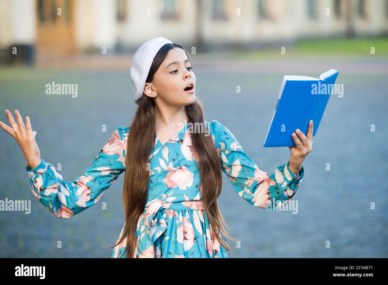 Girl student reading book outdoors, recite poetry concept Stock Photo ...
