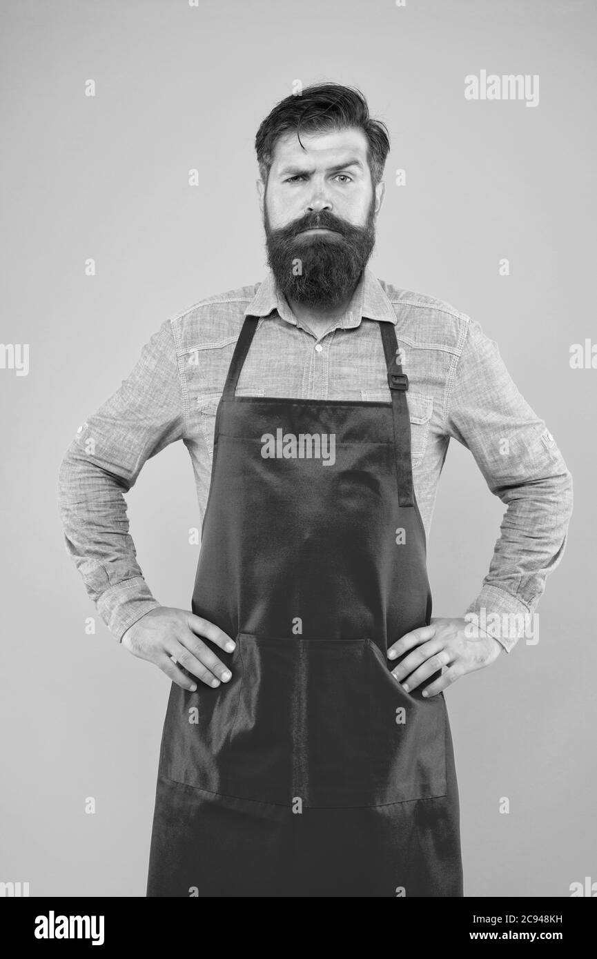 bearded chef or waiter wearing red apron. brutal waiter or barista ...