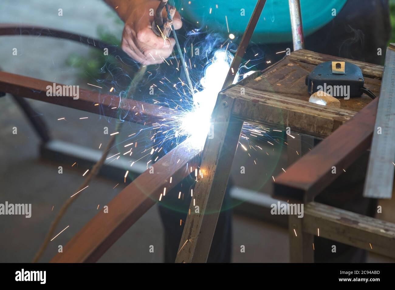 Close-up of hands A man holding a welding machine and doing spot ...
