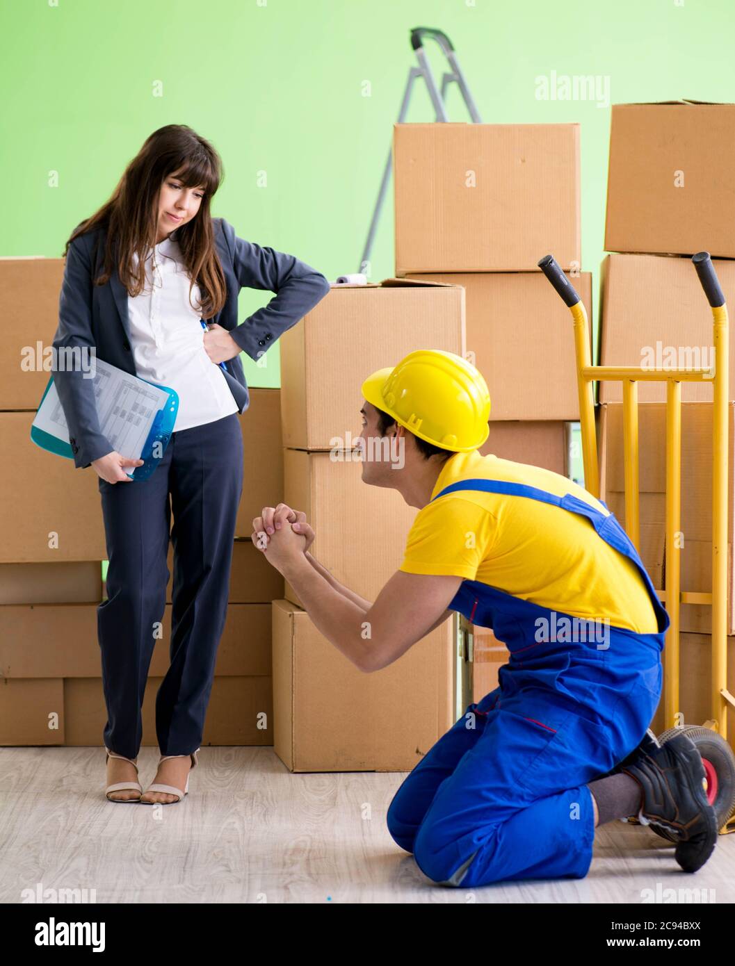 The woman boss and man contractor working with boxes delivery Stock ...
