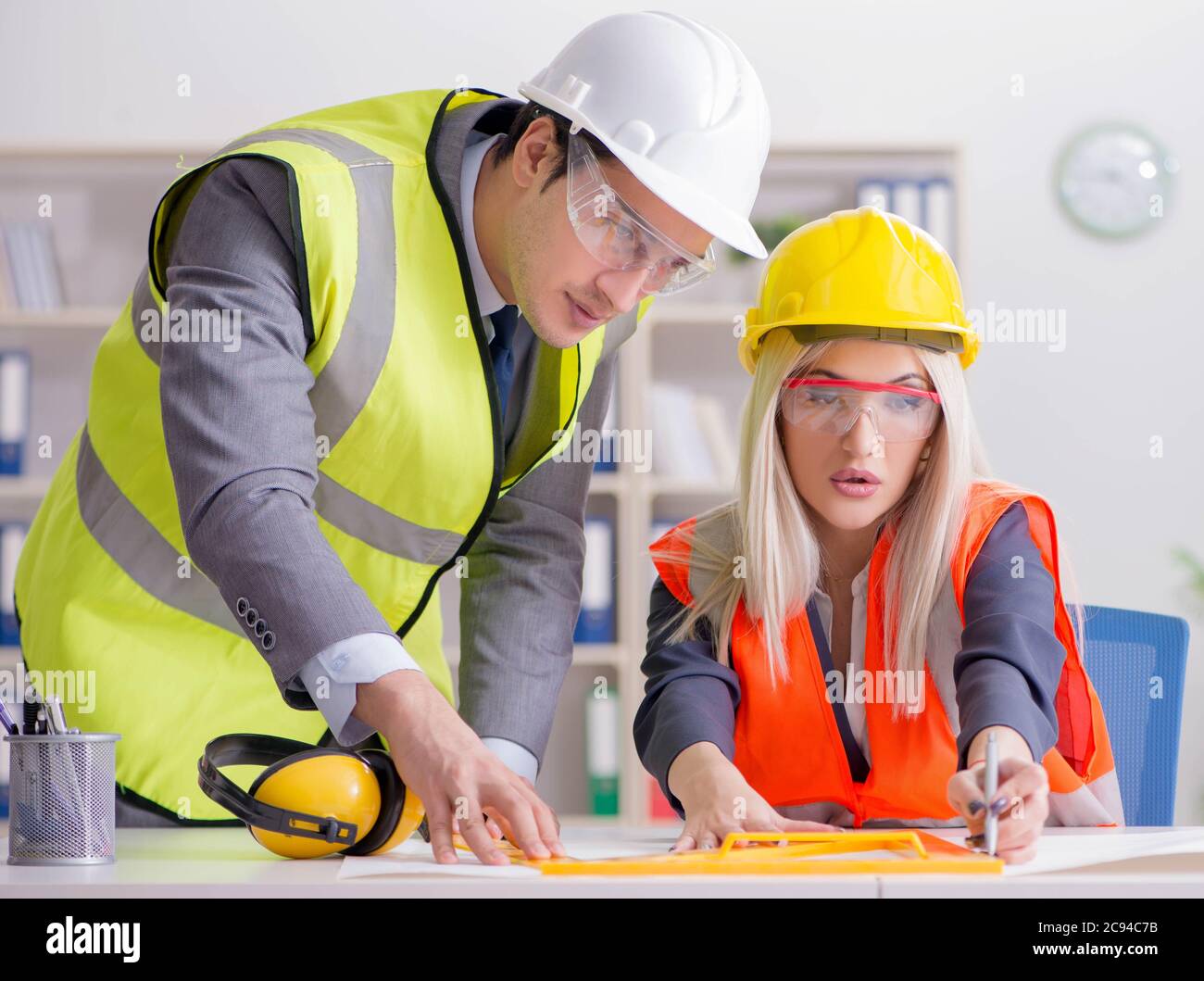 Construction workers having discussion in office before starting ...