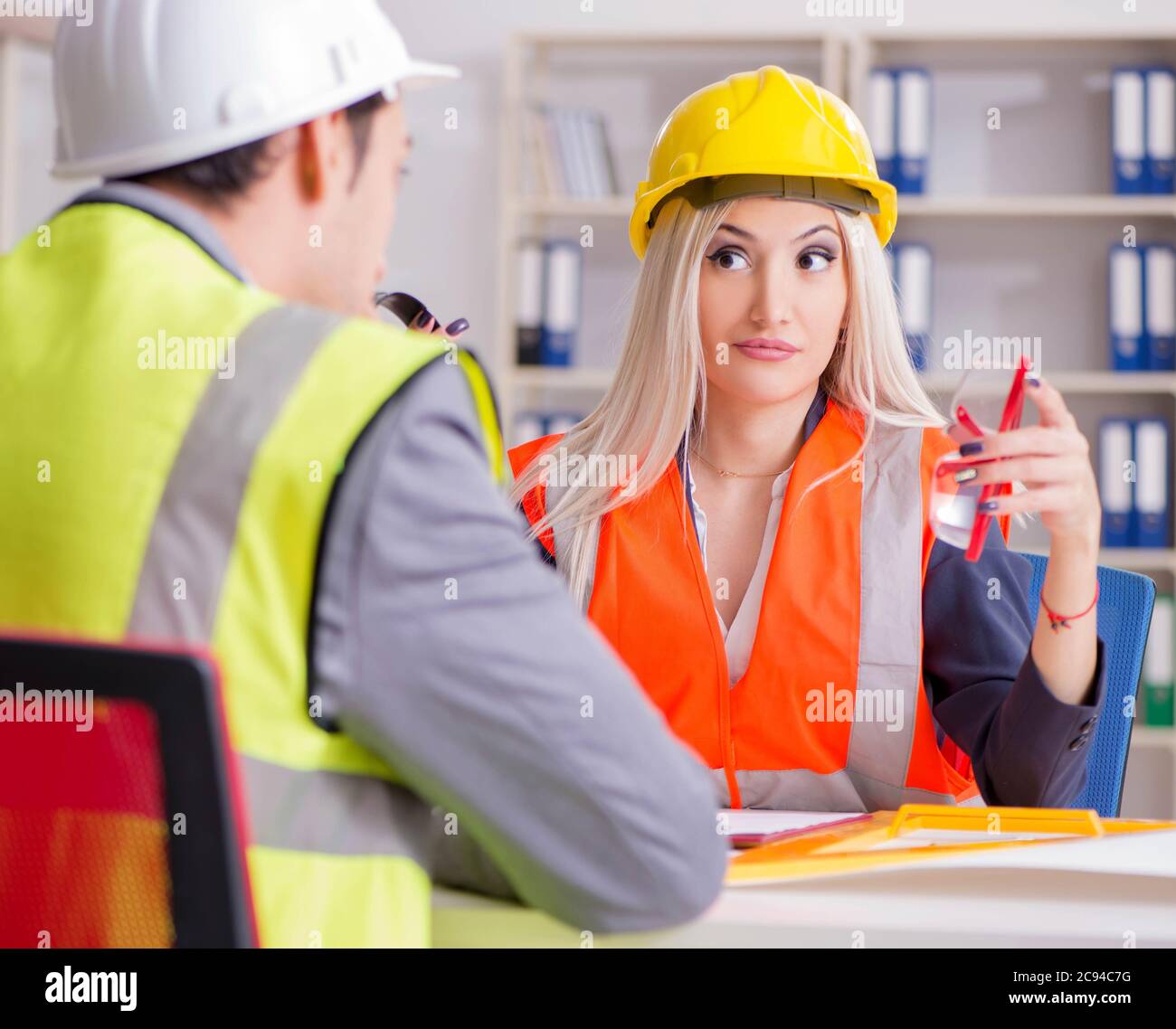 Construction workers having discussion in office before starting ...