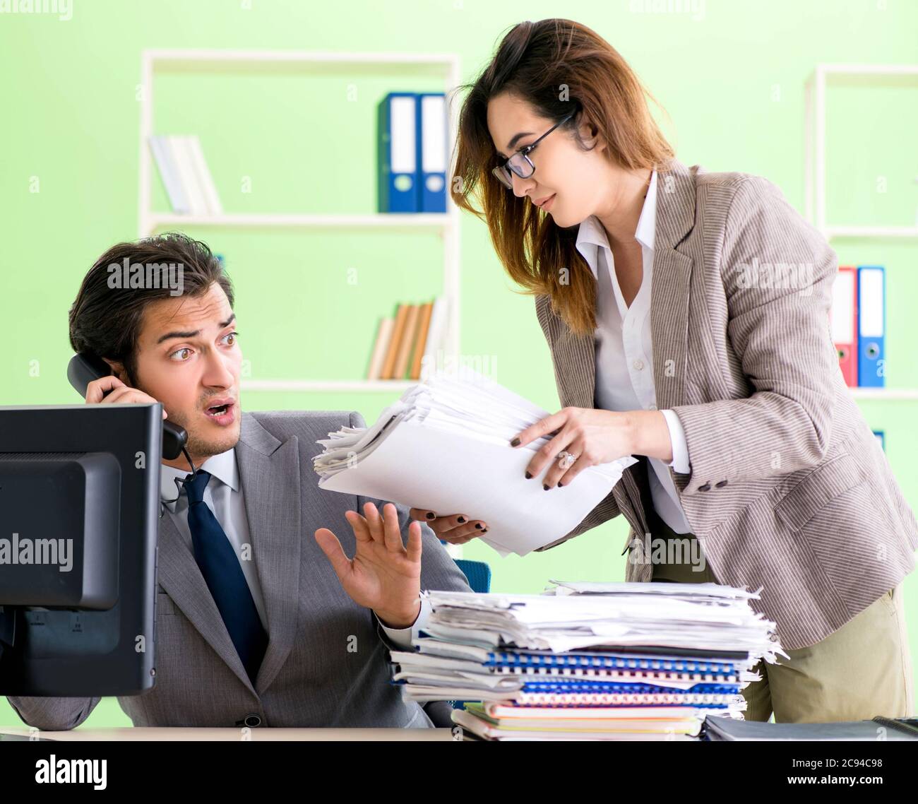 The man employee suffering from excessive work Stock Photo - Alamy