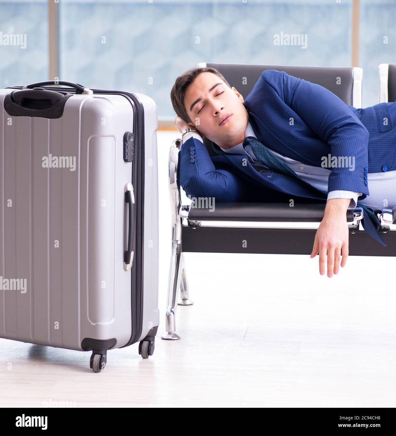 Businessman waiting at the airport for his plane in business class Stock Photo - Alamy