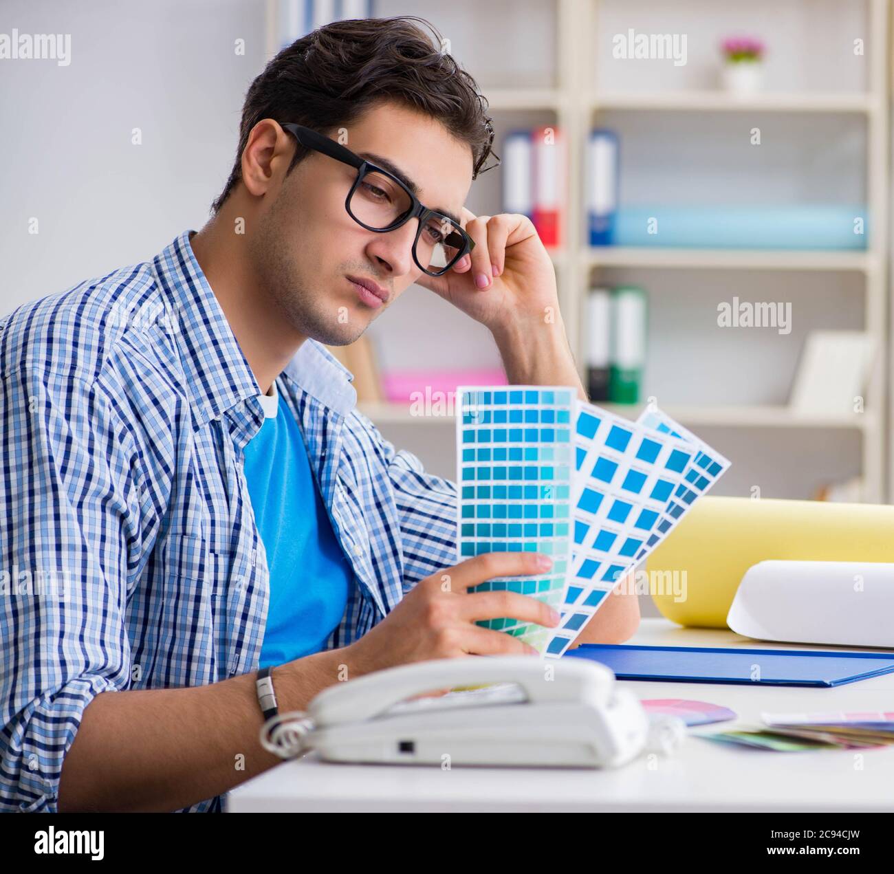 The young designer working on new project and choosing colours Stock ...