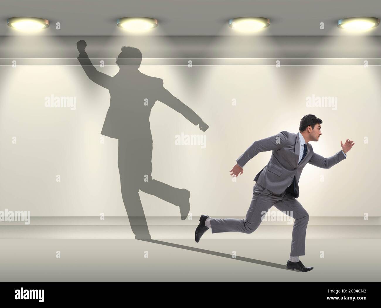 The businessman and his shadow in business concept Stock Photo - Alamy