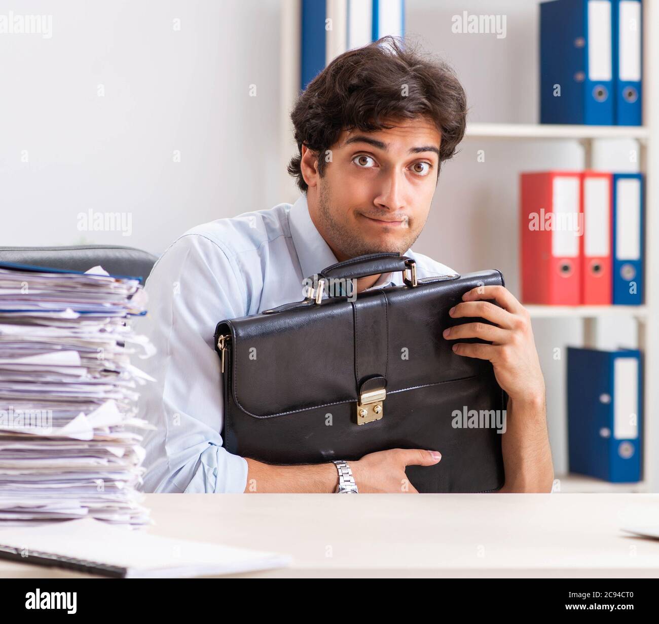 The overloaded busy employee with too much work and paperwork Stock ...