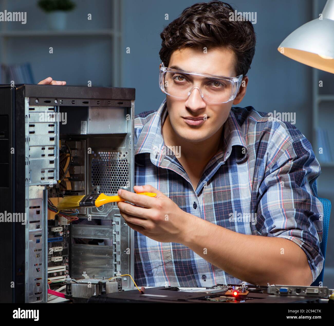 The computer repair man cleaning dust with brush Stock Photo - Alamy