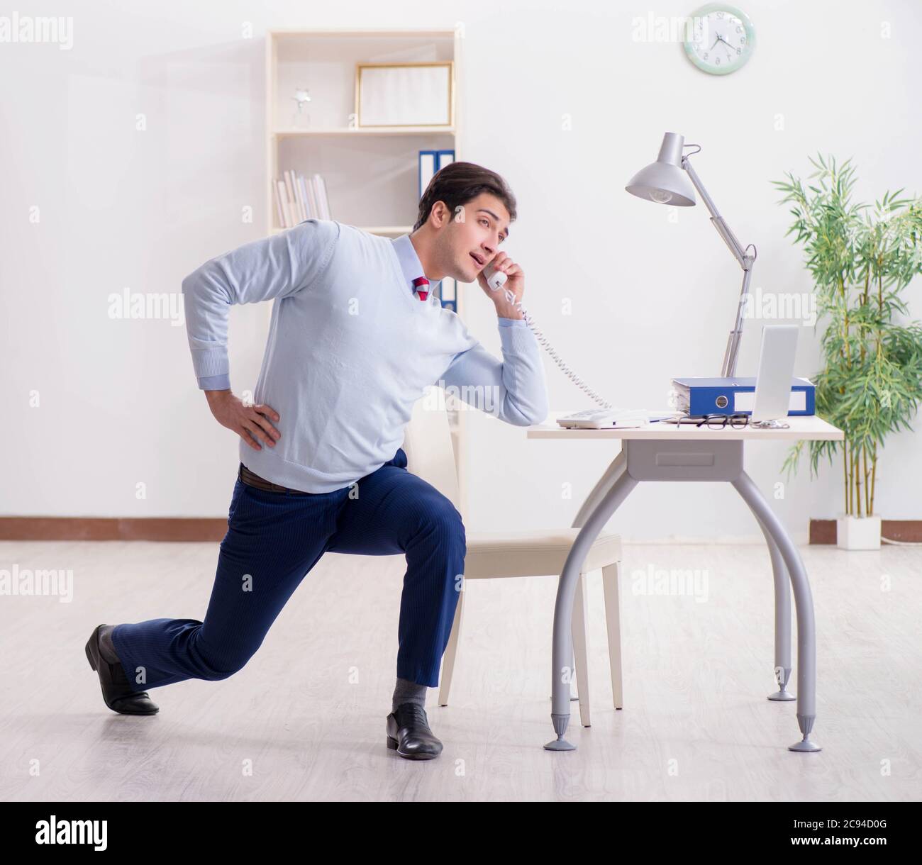 The employee doing stretching exercises in the office Stock Photo - Alamy