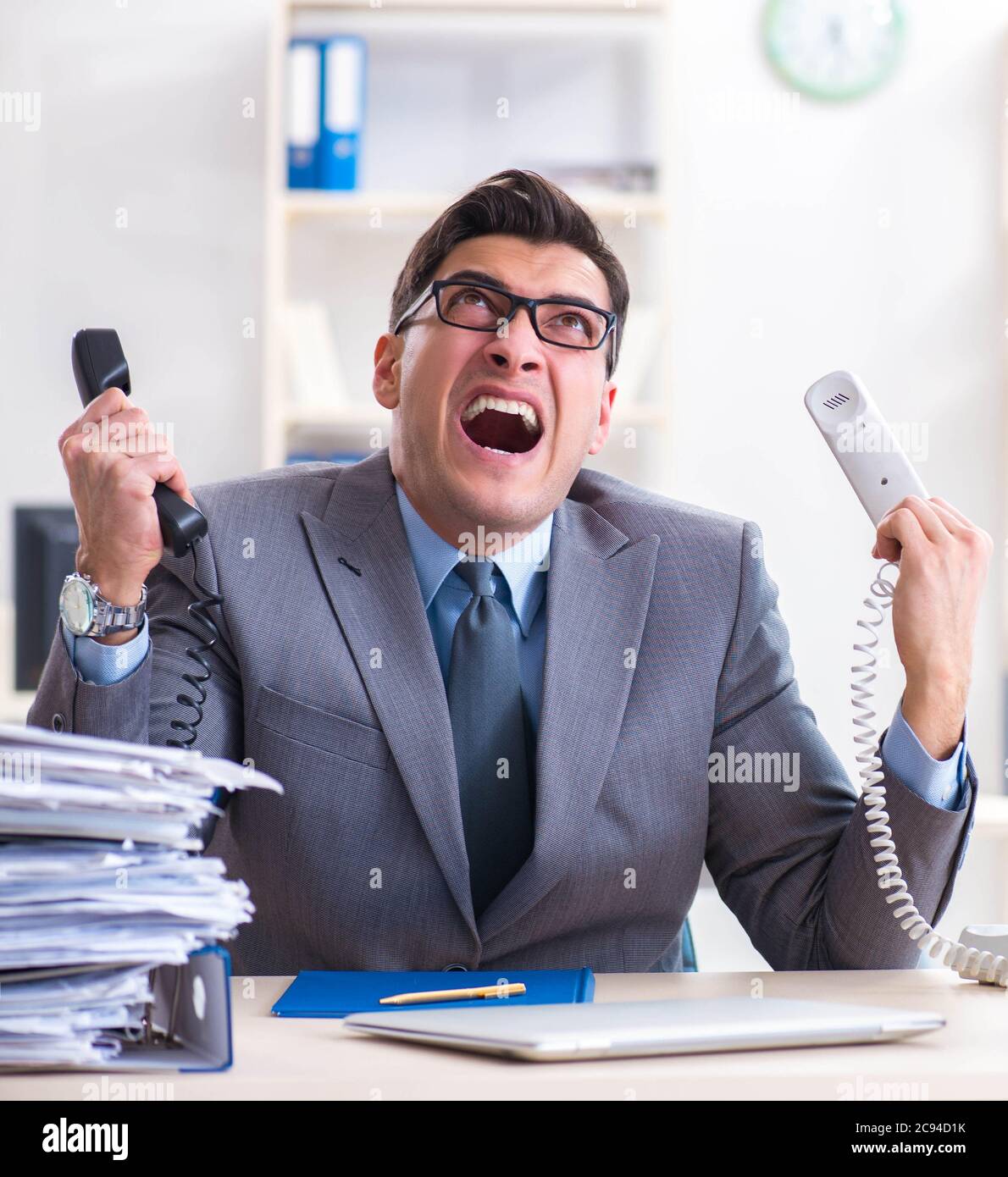 The desperate sad employee tired at his desk in call center Stock Photo ...