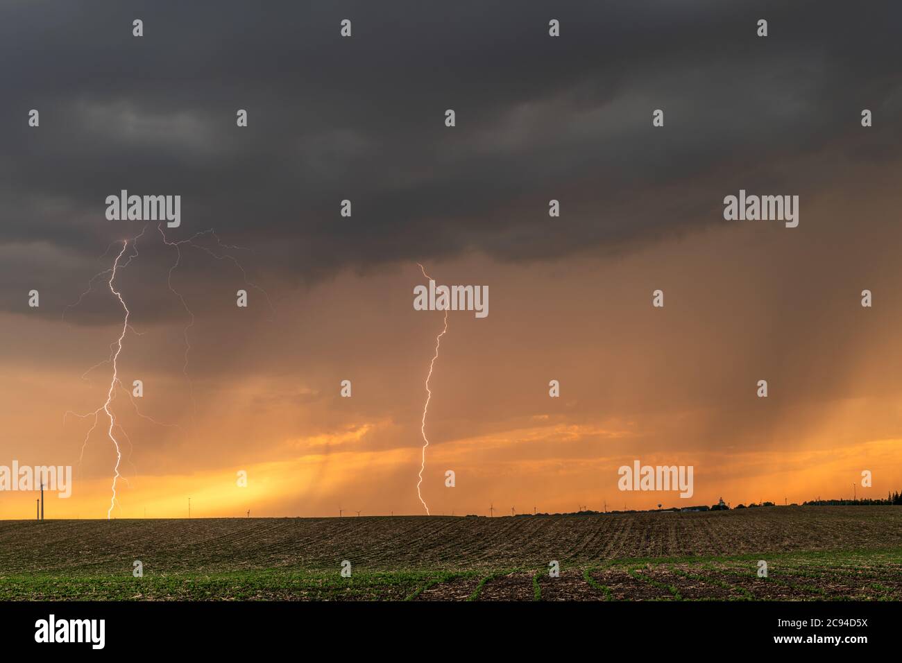 A lightning storm at sunset passes over the Great Plains while pouring ...