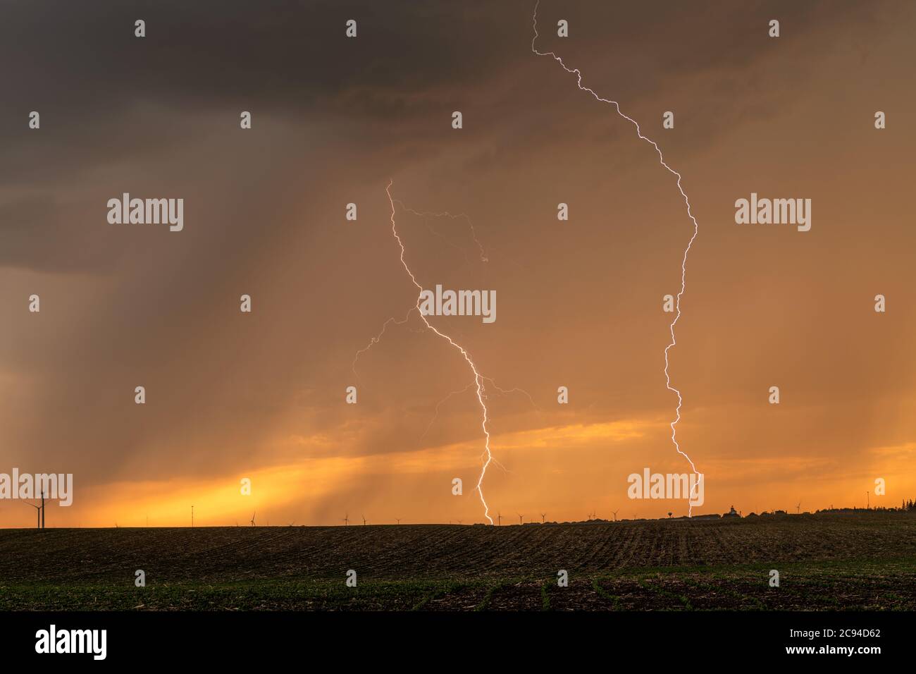 A lightning storm at sunset passes over the Great Plains while pouring ...