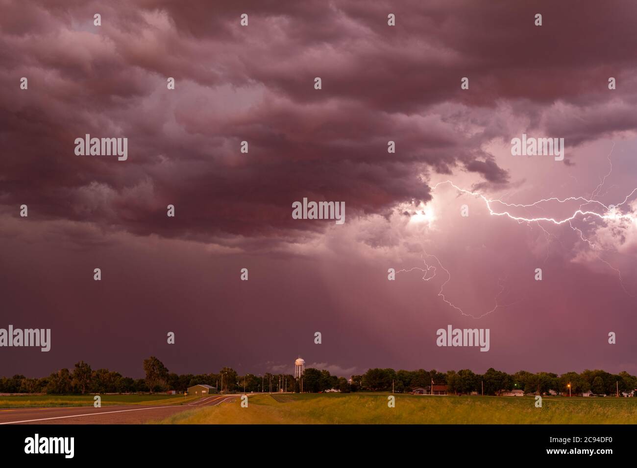 A lightning storm at sunset passes over the Great Plains while pouring ...