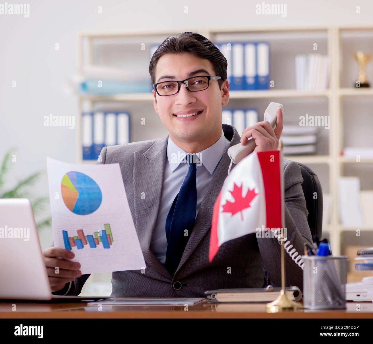 The businessman with canadian flag in office Stock Photo - Alamy