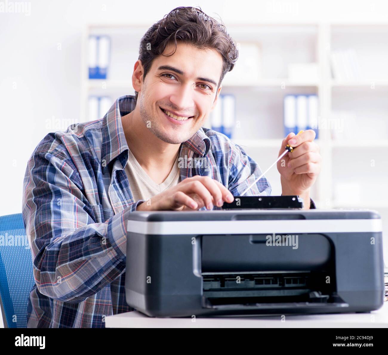 The hardware repairman repairing broken printer fax machine Stock Photo ...