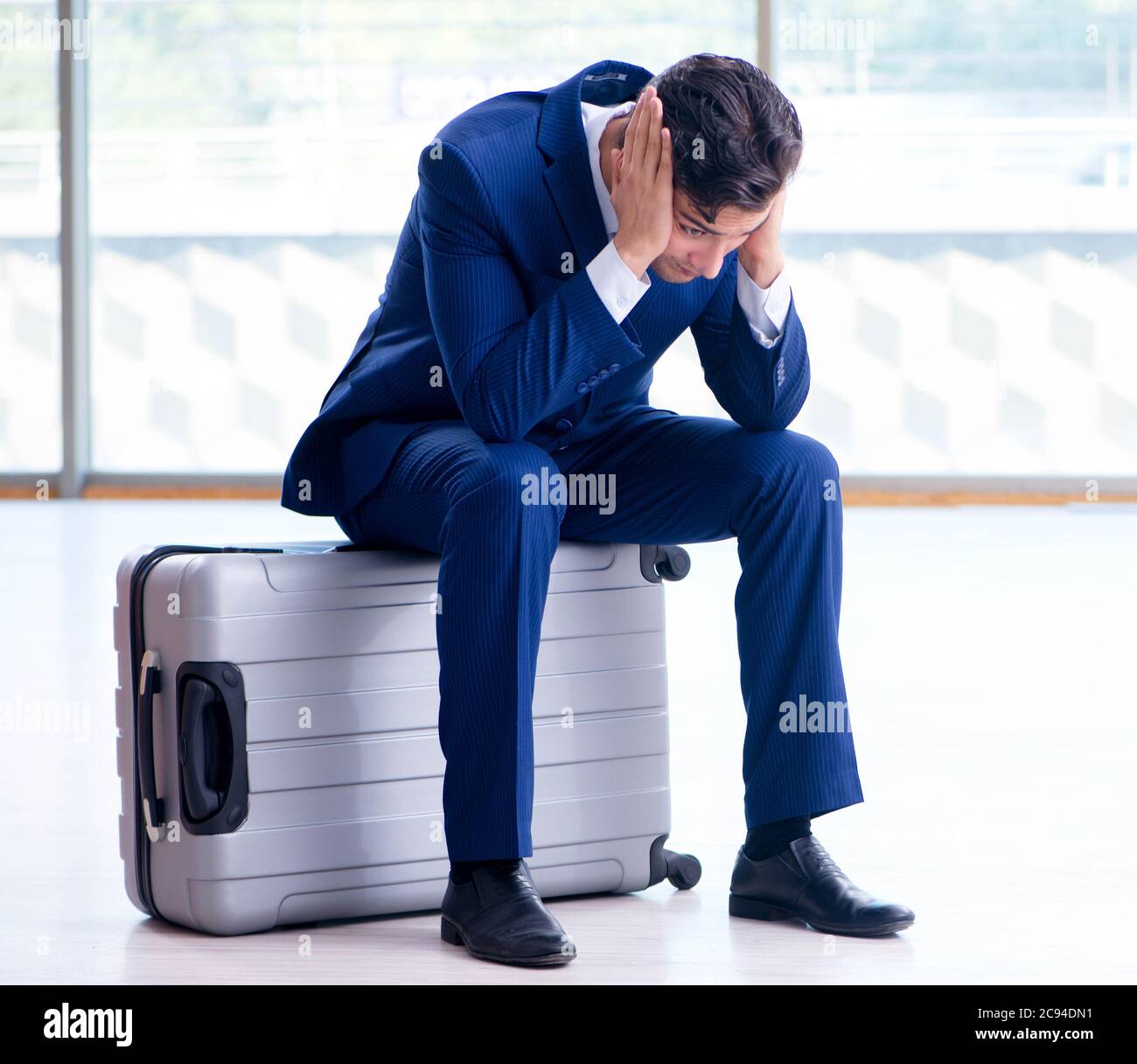 The businessman waiting for his flight at airport Stock Photo - Alamy