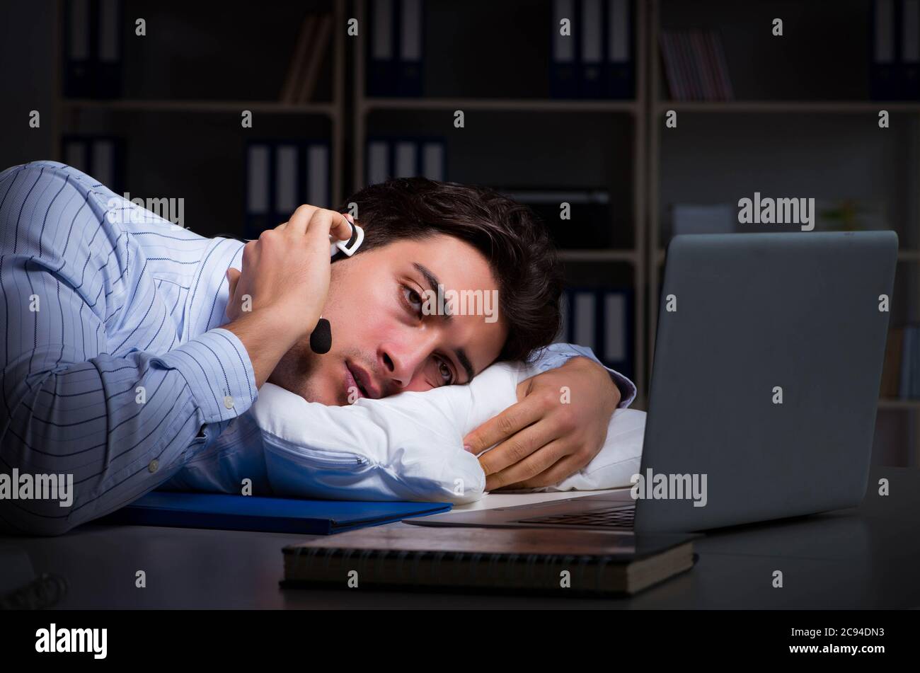 The tired and exhausted helpdesk operator during night shift Stock ...
