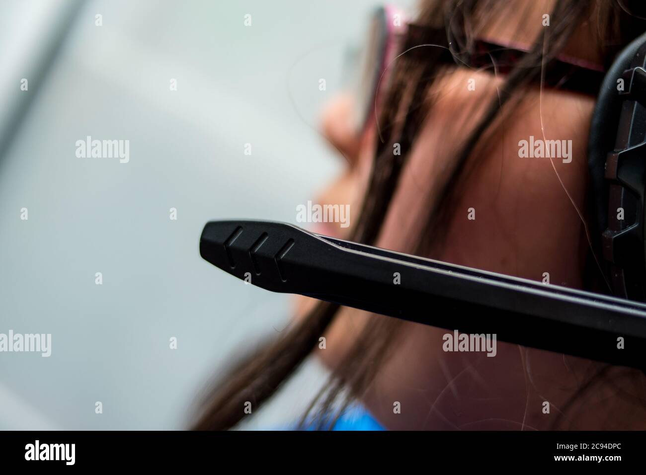 Girl with some headphones with a microphone Stock Photo - Alamy