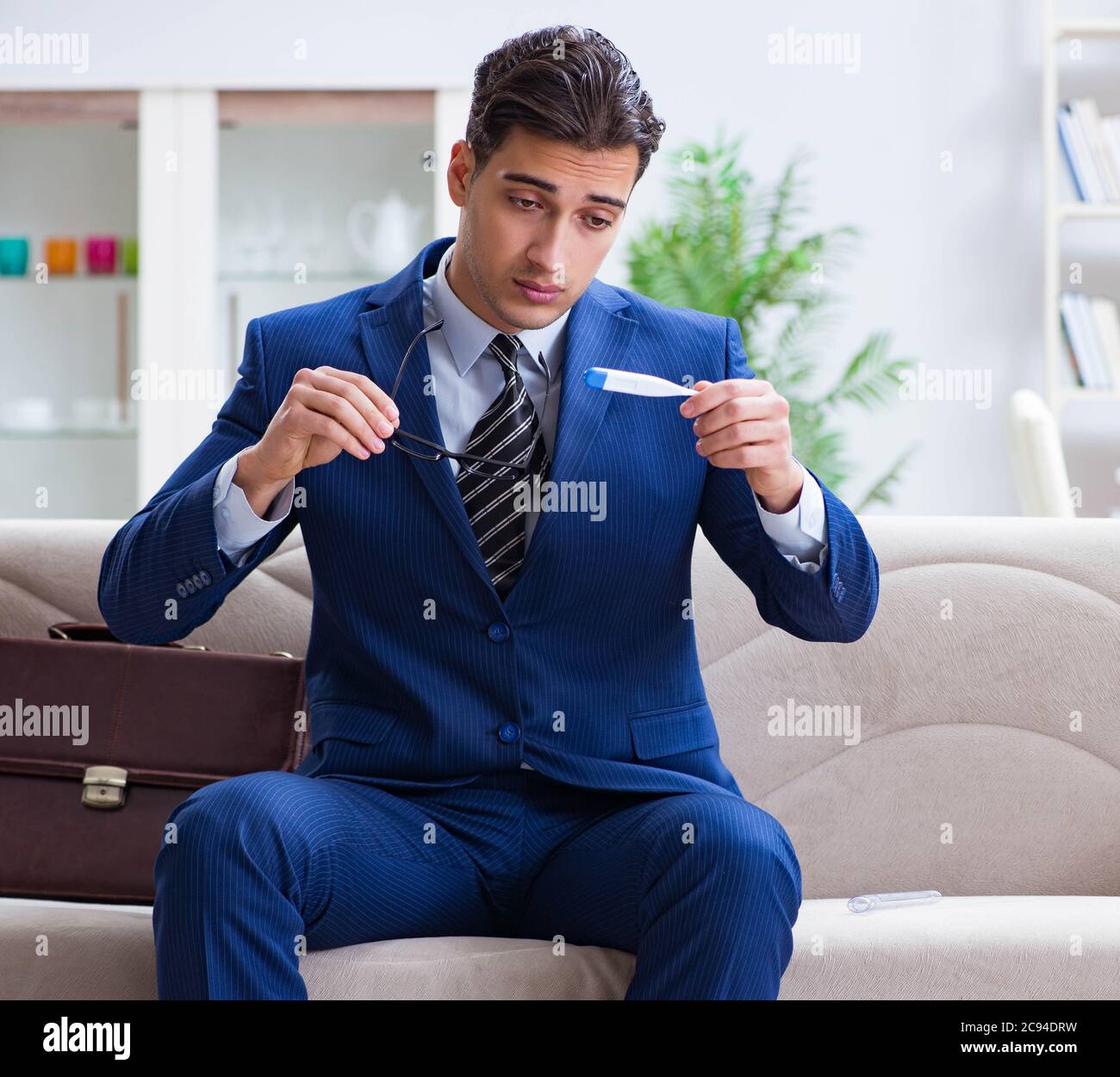 The sick employee staying at home suffering from flue Stock Photo - Alamy